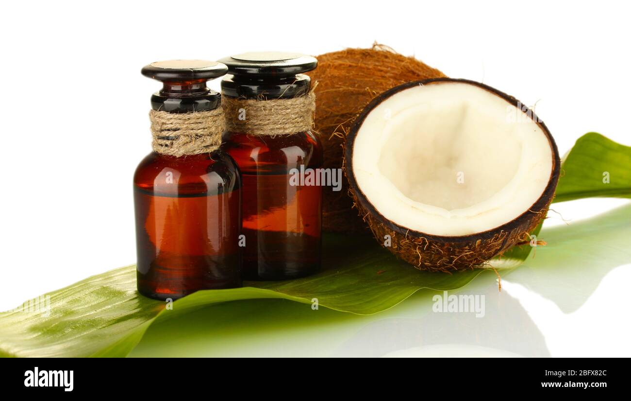 coconut oil in bottles with coconuts on white background Stock Photo ...