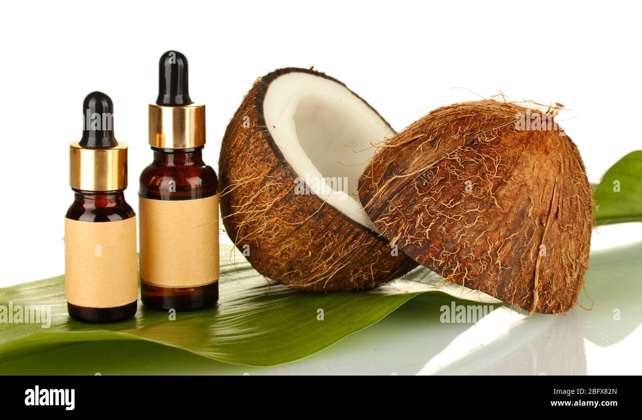 coconut oil in bottles with coconuts on white background Stock Photo ...