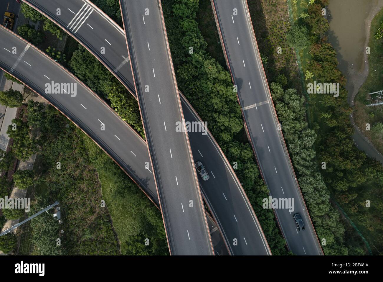 Aerial view of single car driving on highway and overpass Stock Photo ...