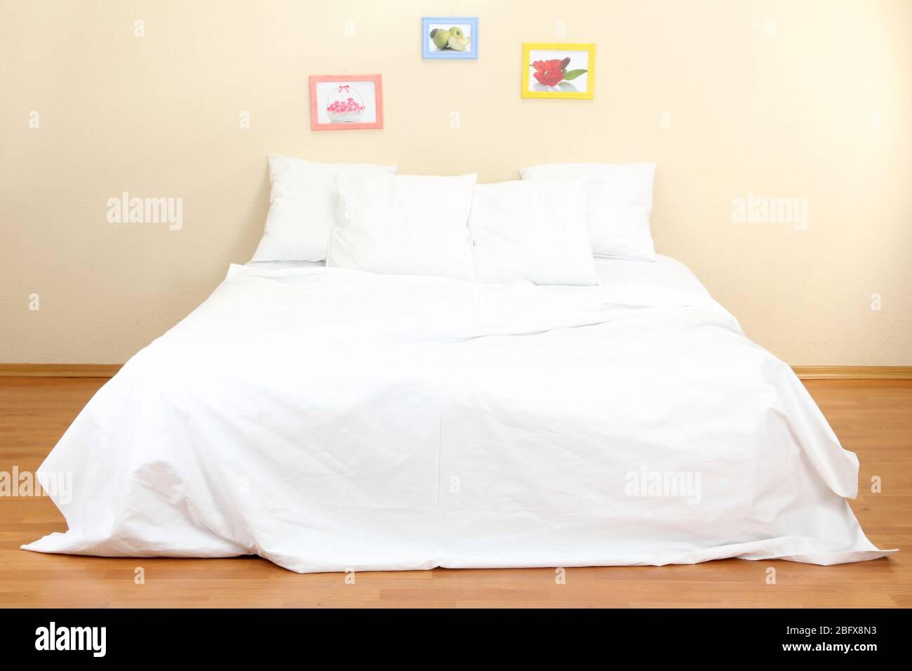 Empty bed with pillows and sheets in bedroom Stock Photo - Alamy