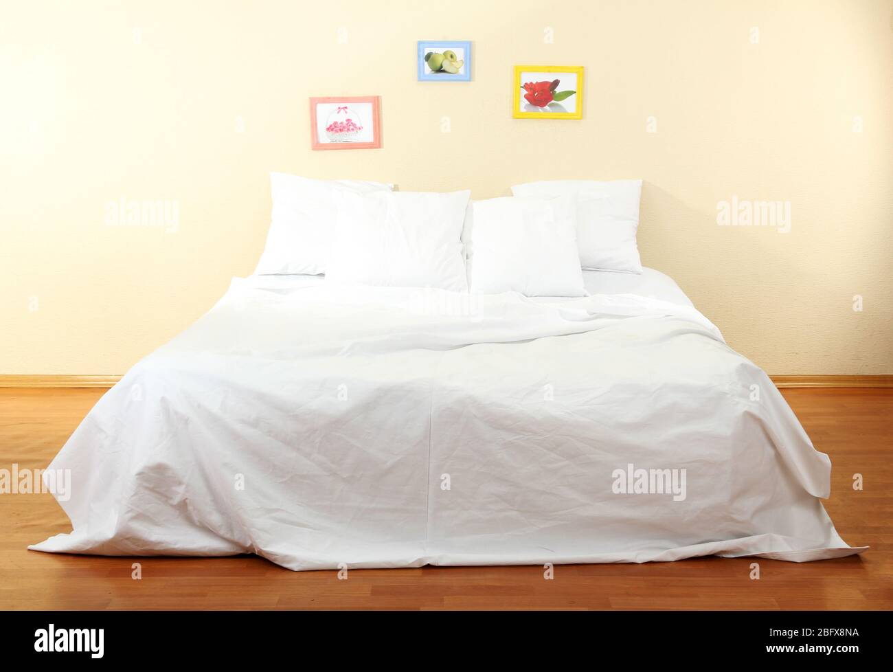 Empty bed with pillows and sheets in bedroom Stock Photo - Alamy