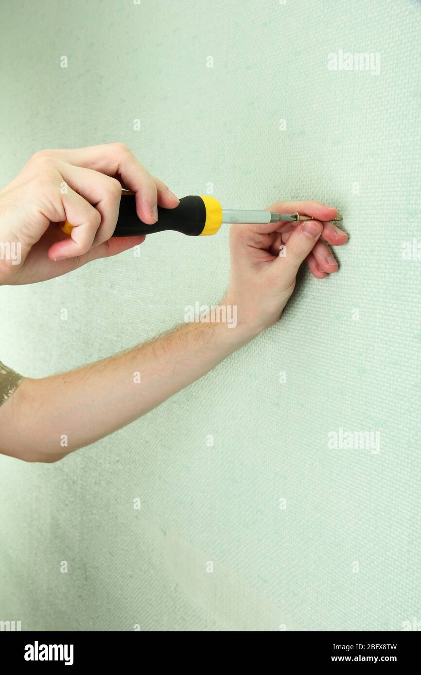 man hands with screwdriver and screw Stock Photo - Alamy