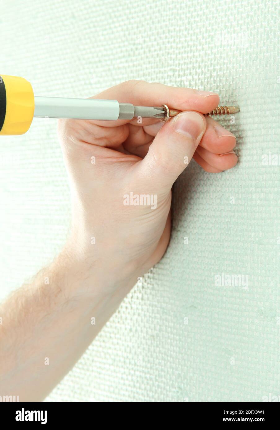 man hands with screwdriver and screw Stock Photo - Alamy