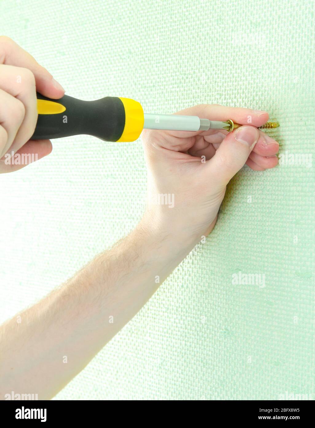 man hands with screwdriver and screw Stock Photo - Alamy