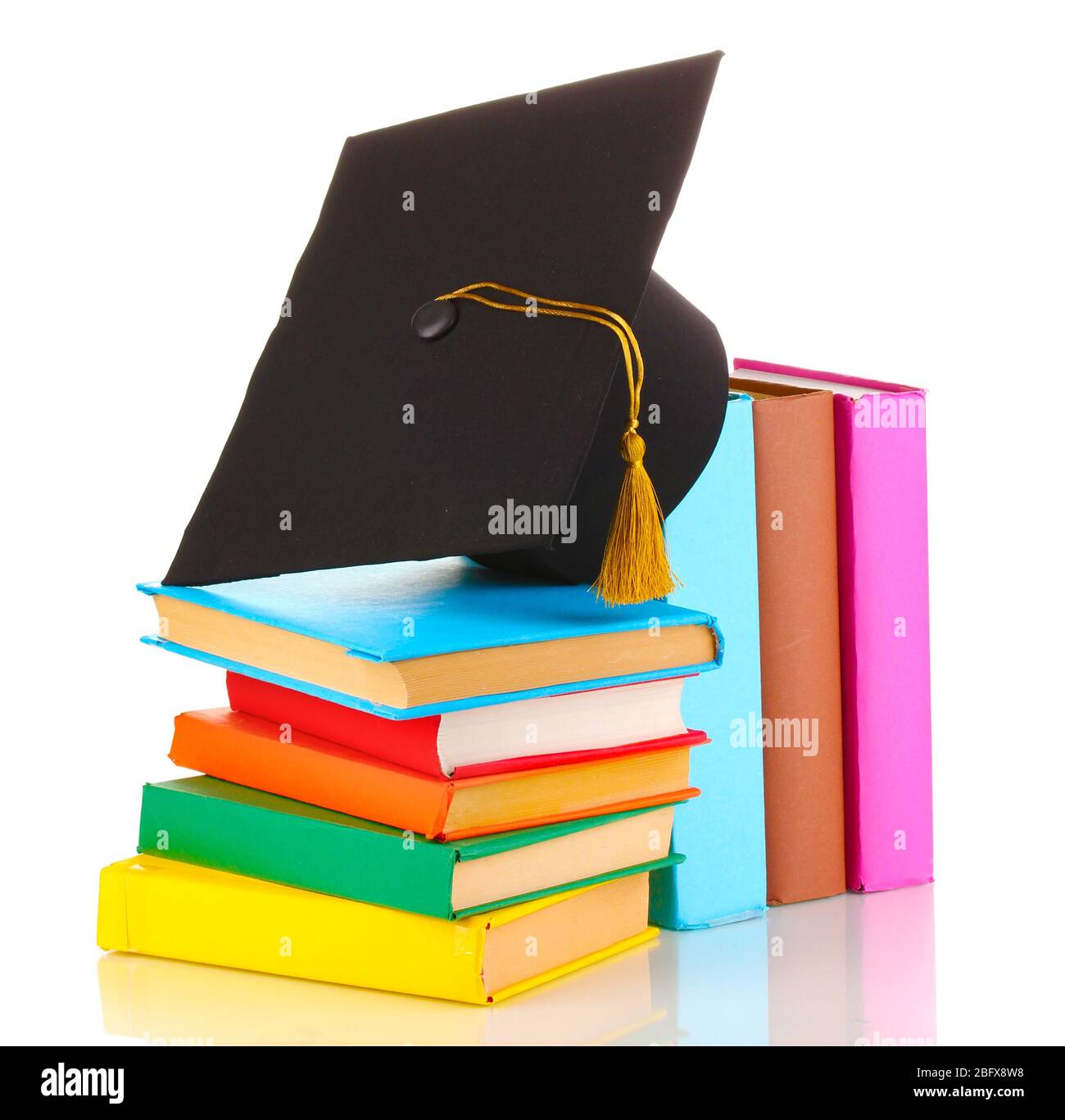 Grad hat with books isolated on white Stock Photo - Alamy