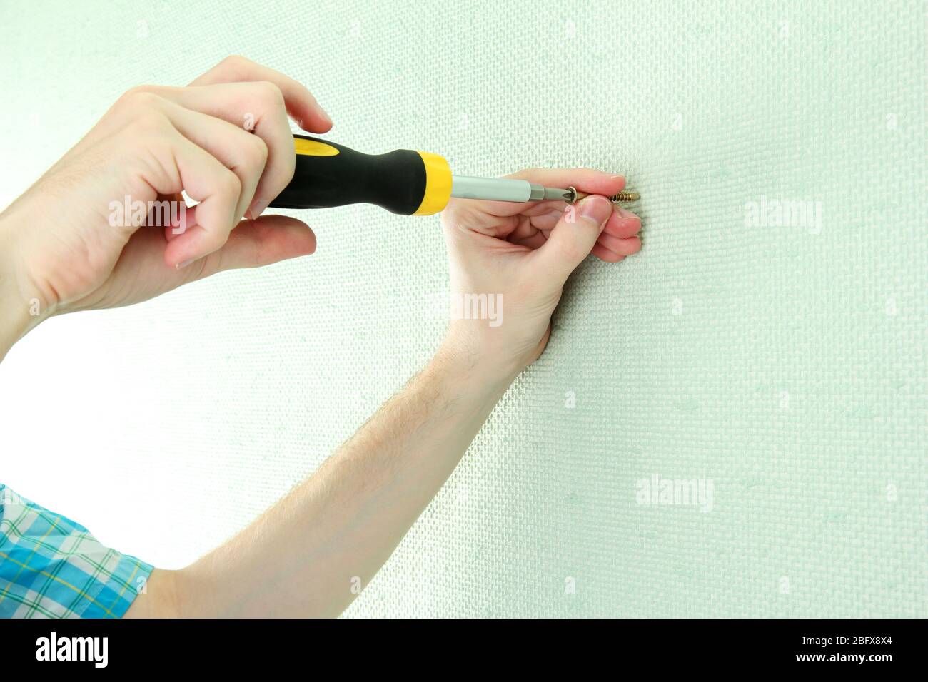 man hands with screwdriver and screw Stock Photo - Alamy