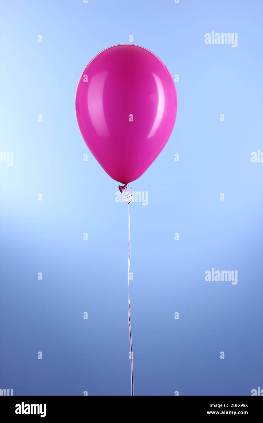 Purple one balloon on blue background Stock Photo - Alamy
