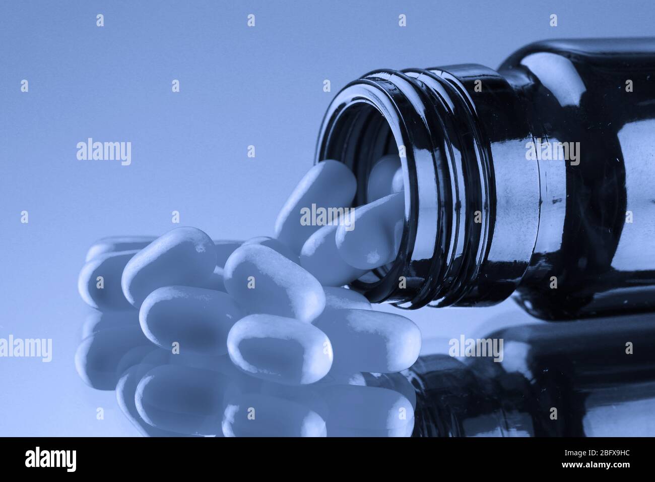 Assortment of tablets in blue light Stock Photo - Alamy