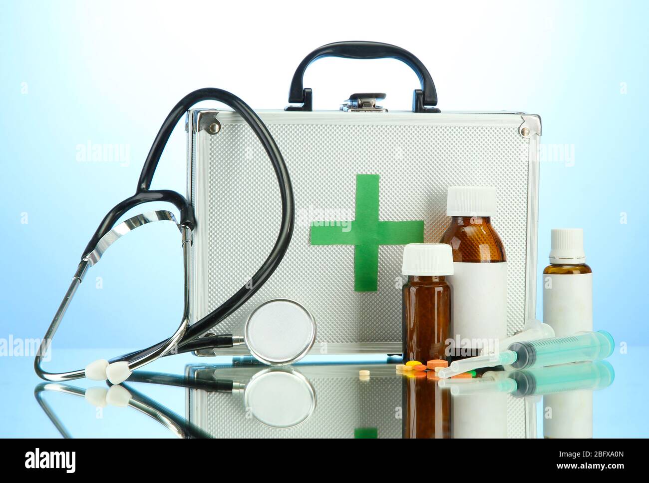 First aid box, on blue background Stock Photo - Alamy