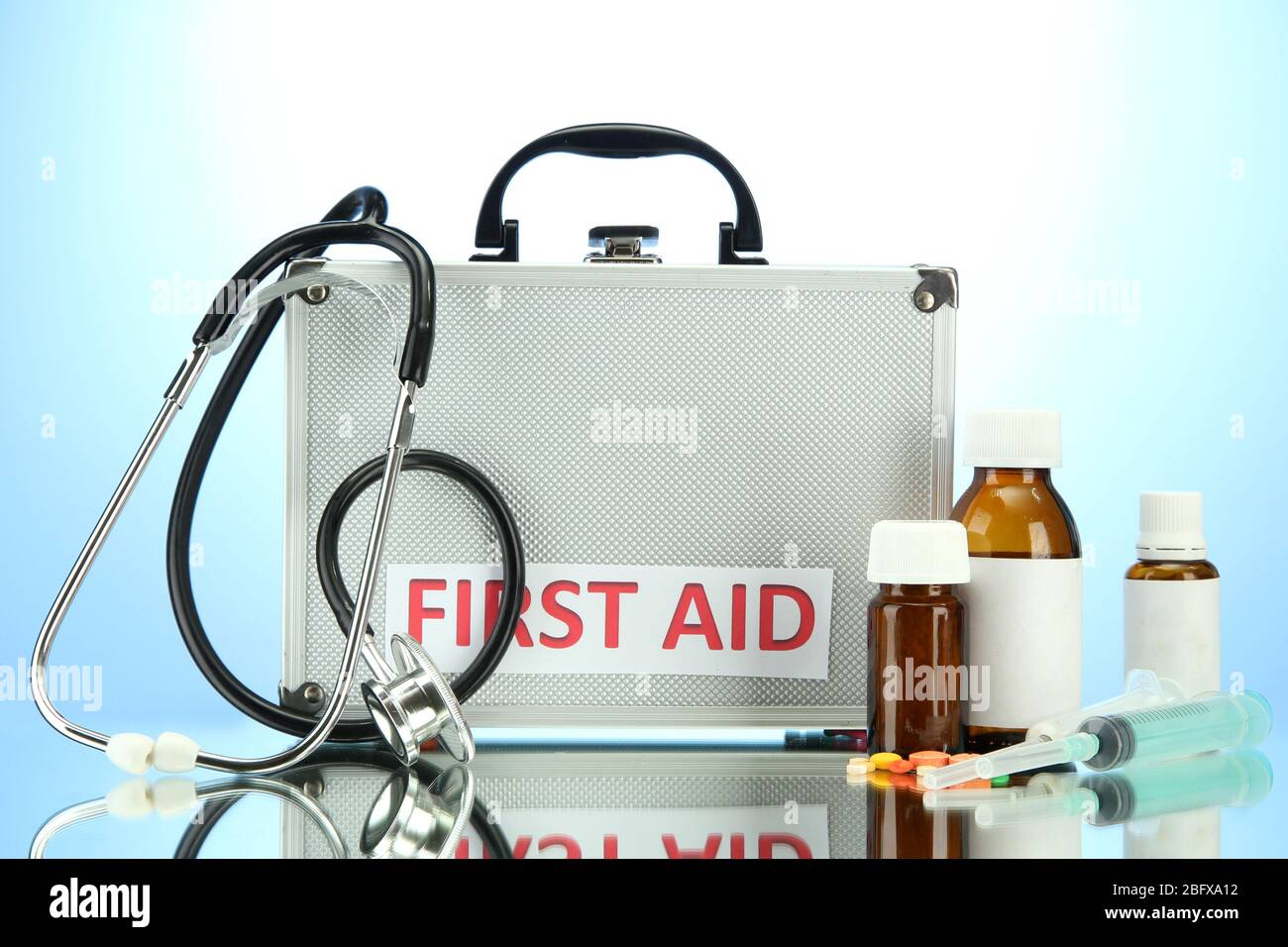 First aid box, on blue background Stock Photo - Alamy