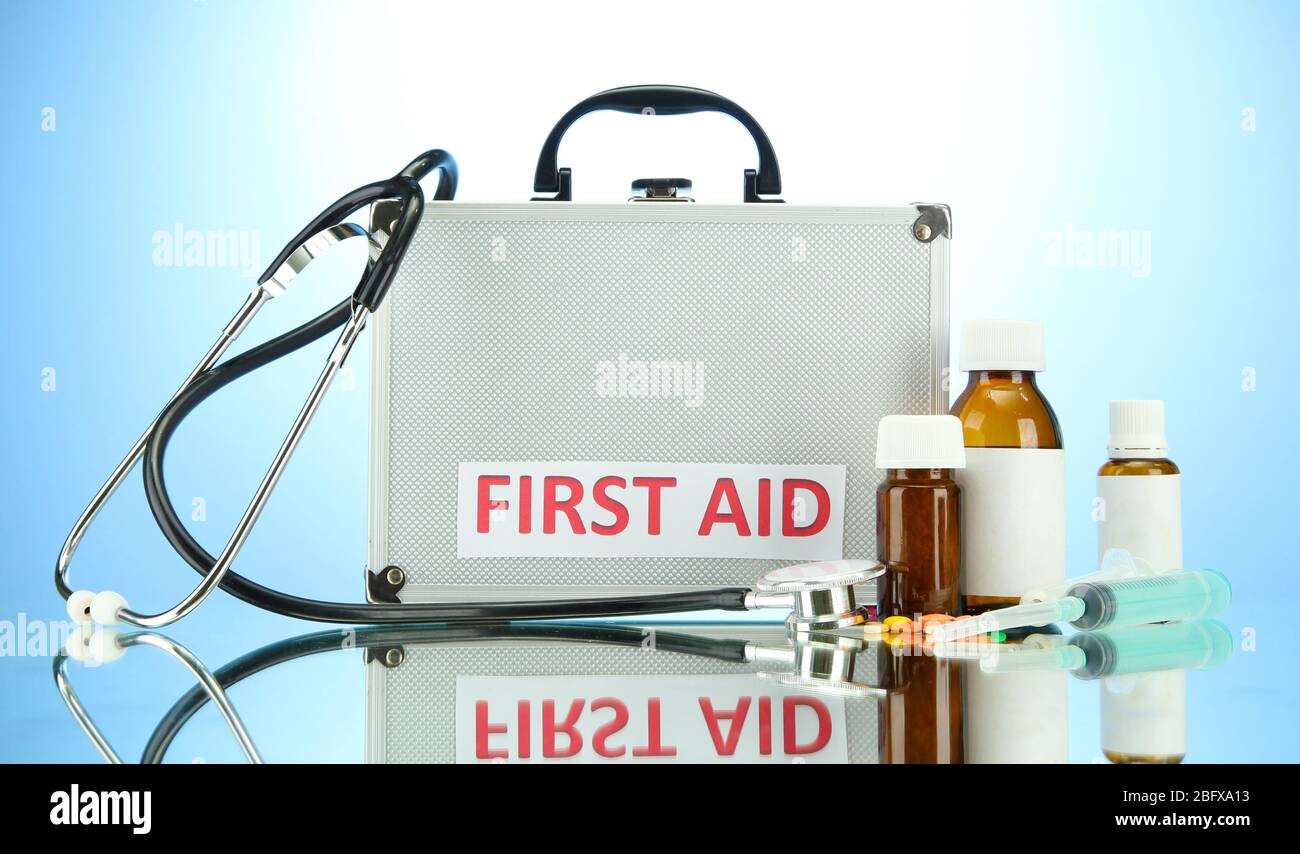 First aid box, on blue background Stock Photo - Alamy