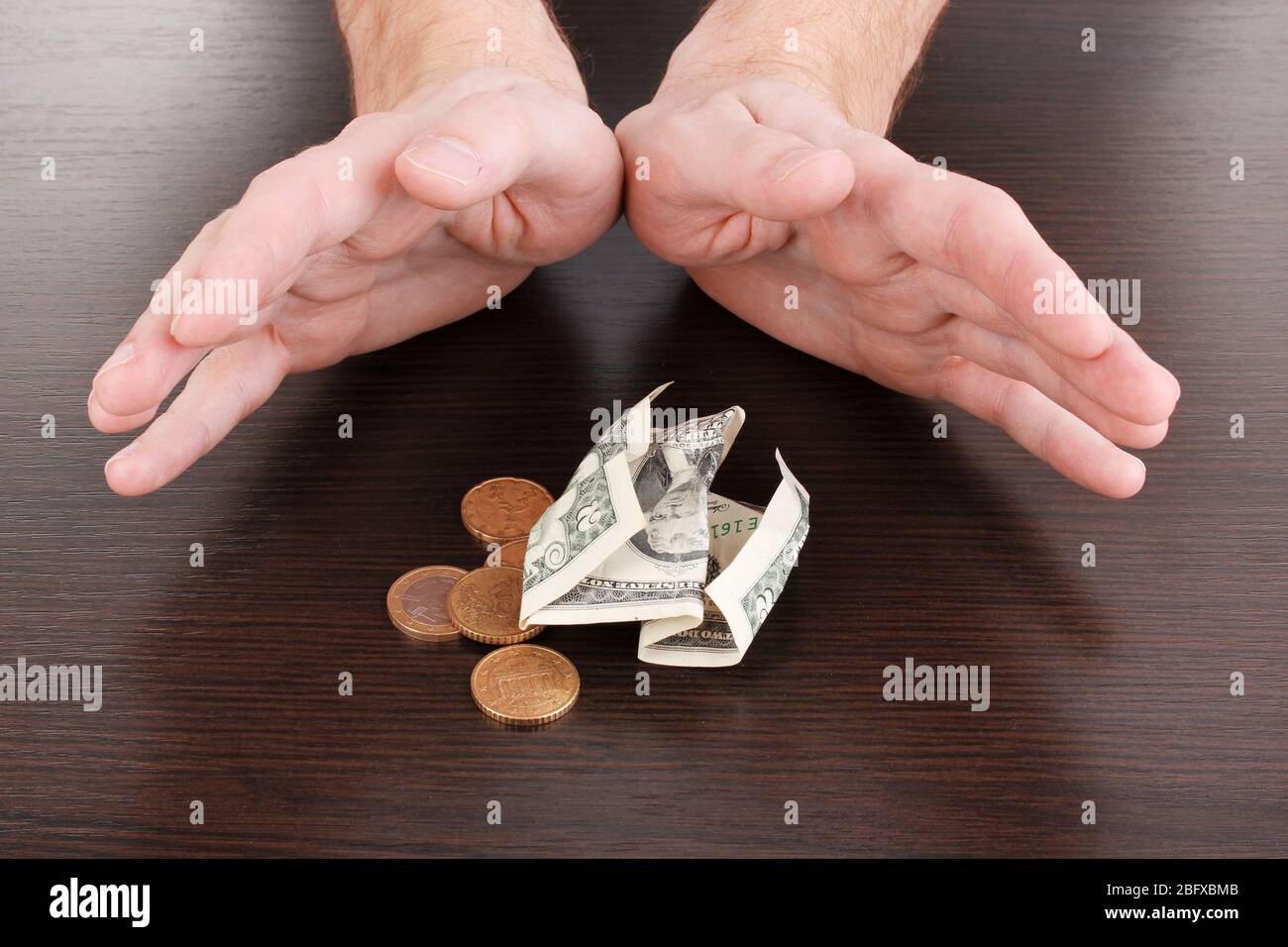 Money, which take hands on wooden table background Stock Photo - Alamy