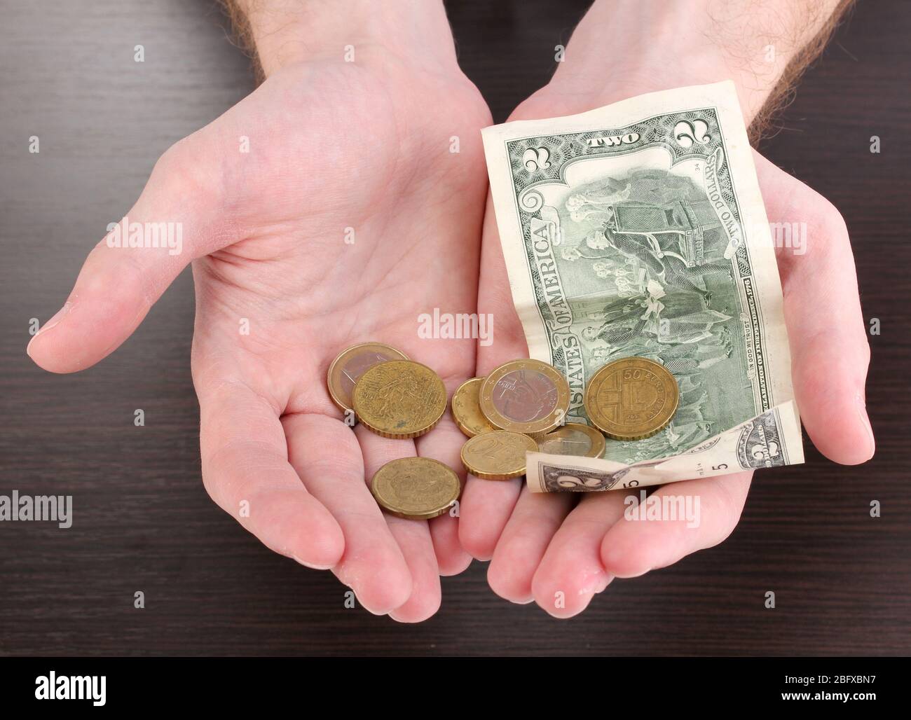 Counting money in hand on wooden table background Stock Photo - Alamy