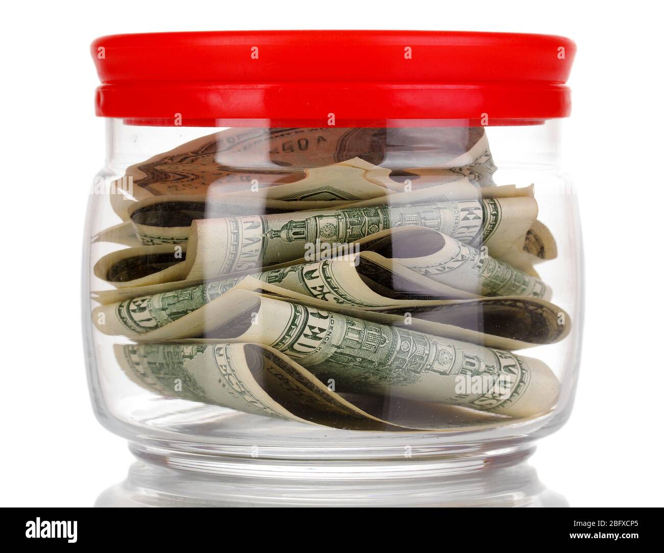 Clear glass jar for tips with money isolated on white Stock Photo - Alamy