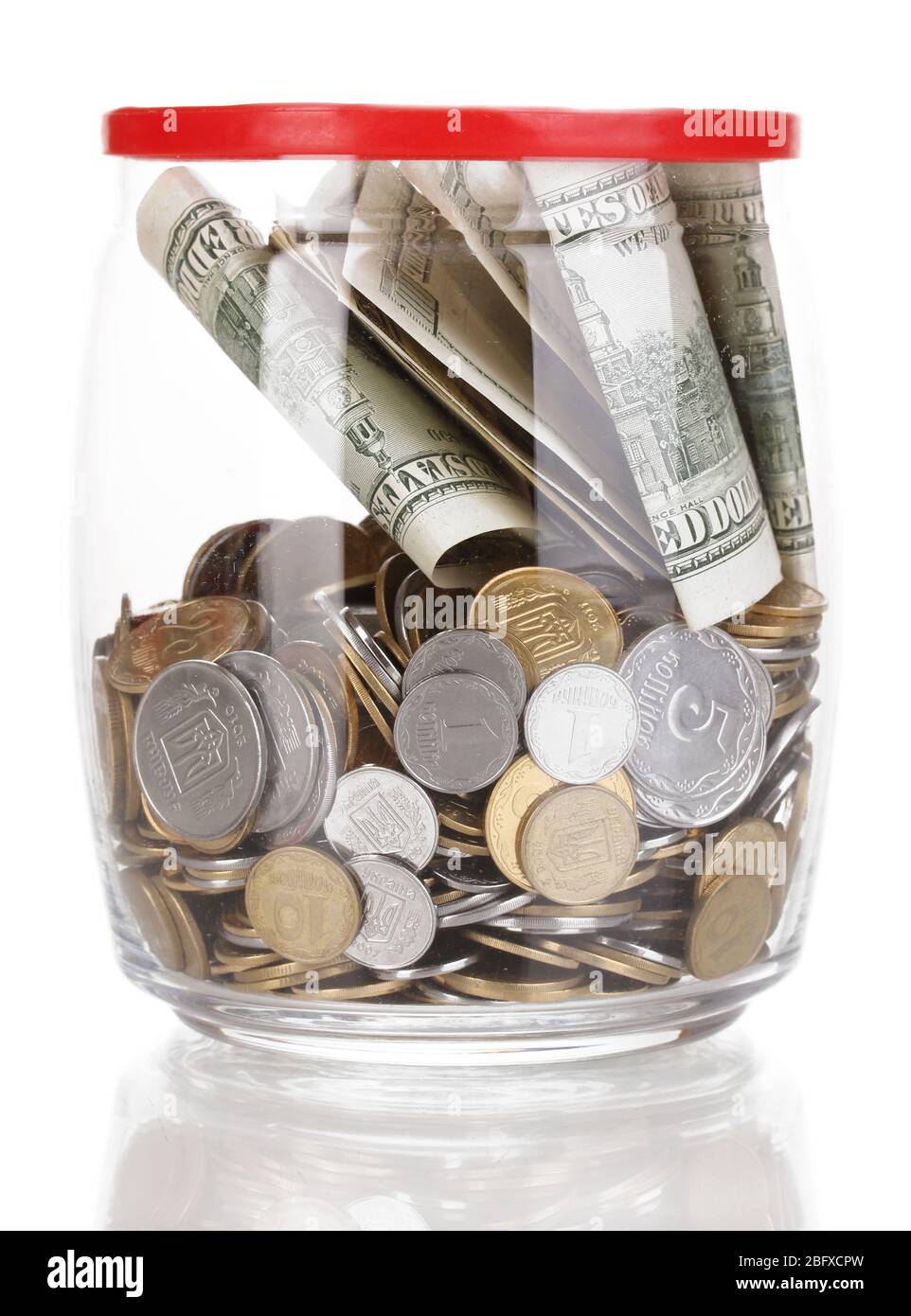 Clear glass jar for tips with money isolated on white Stock Photo - Alamy