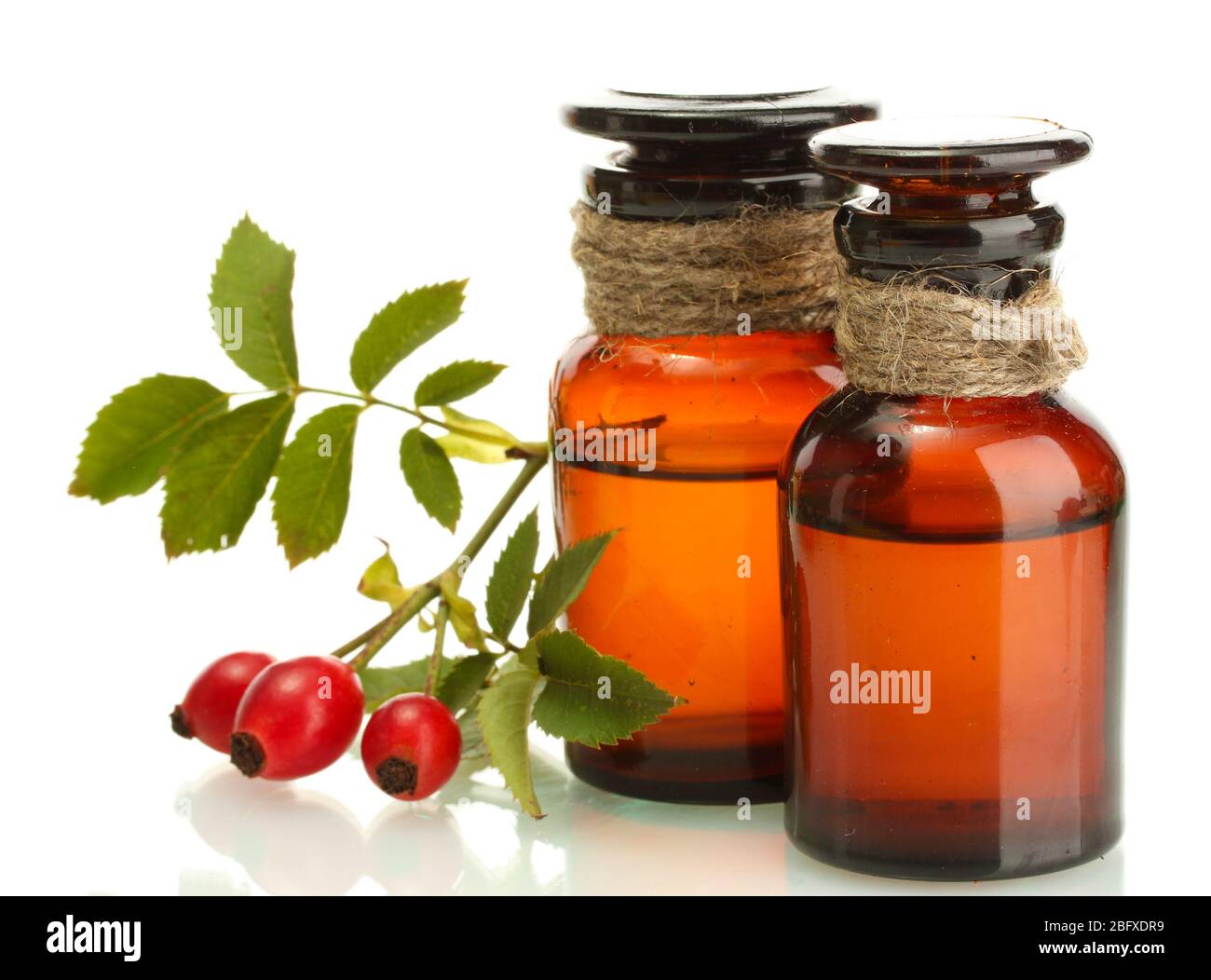 medicine bottles with hip roses, isolated on white Stock Photo - Alamy
