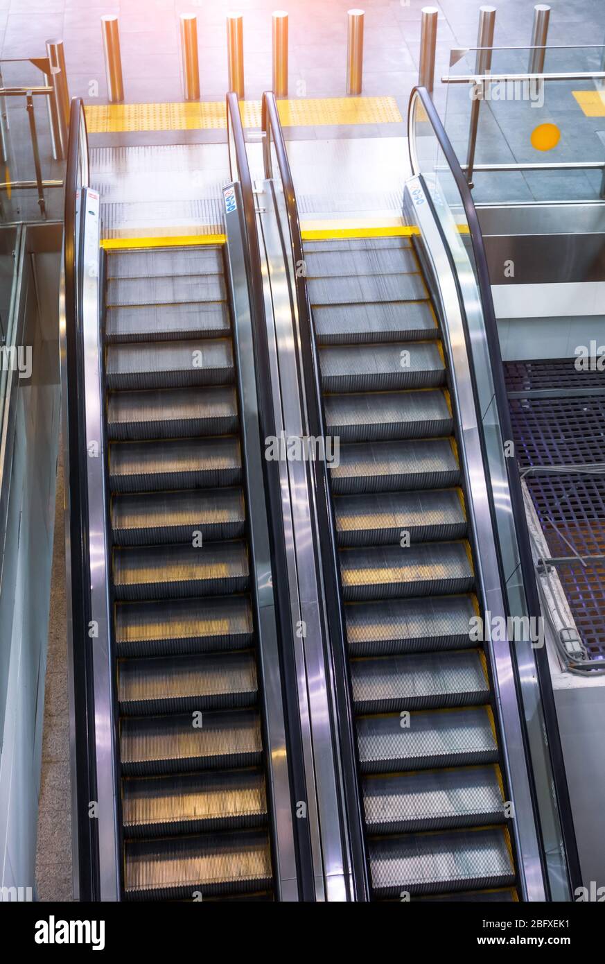 Two escalator stairs up and down to different floors of the building ...