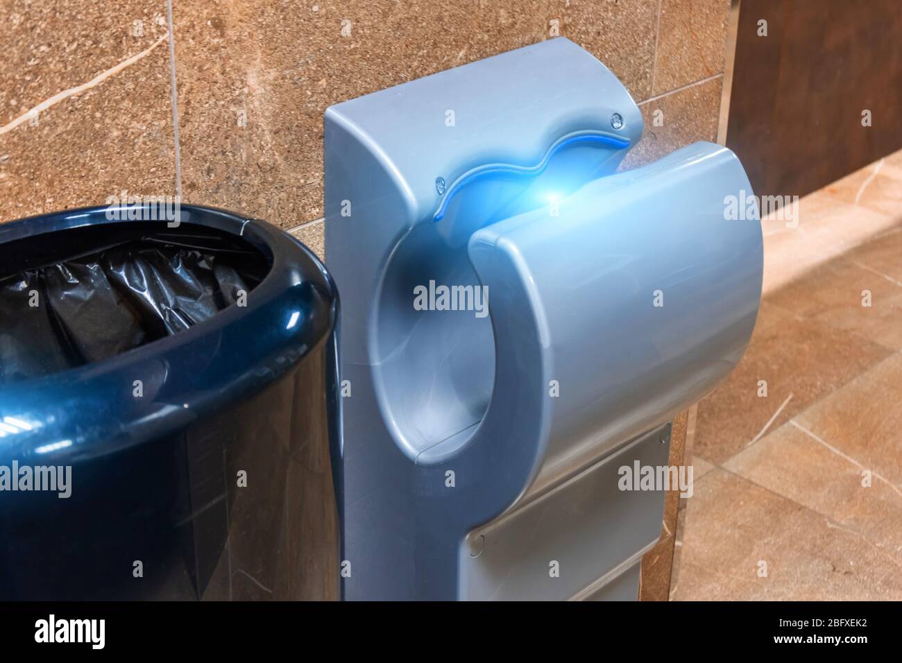 Modern vertical hand dryer with ultraviolet radiation and bin for used ...