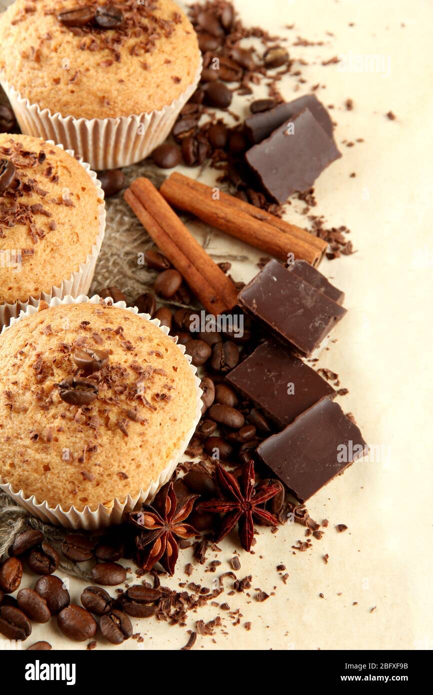 tasty muffin cakes with chocolate, spices and coffee seeds, on beige ...