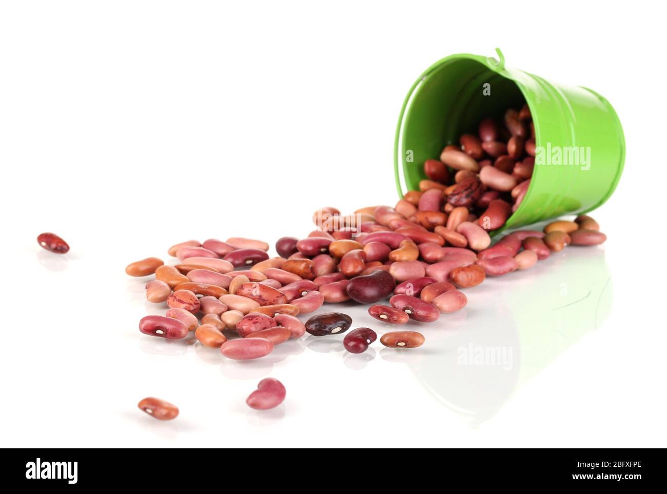 Brown beans in green bucket isolated on white Stock Photo - Alamy