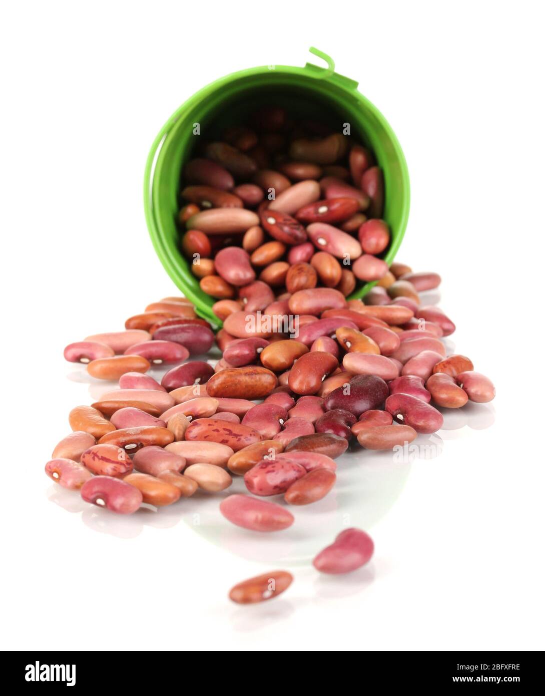 Brown beans in green bucket isolated on white Stock Photo - Alamy