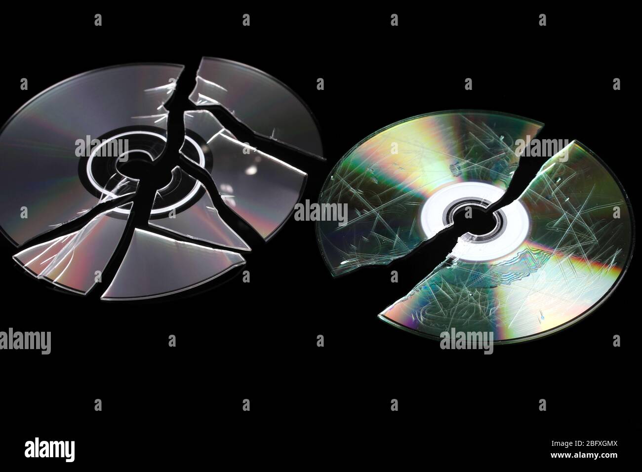 Defective and broken disks with information isolated on black Stock ...
