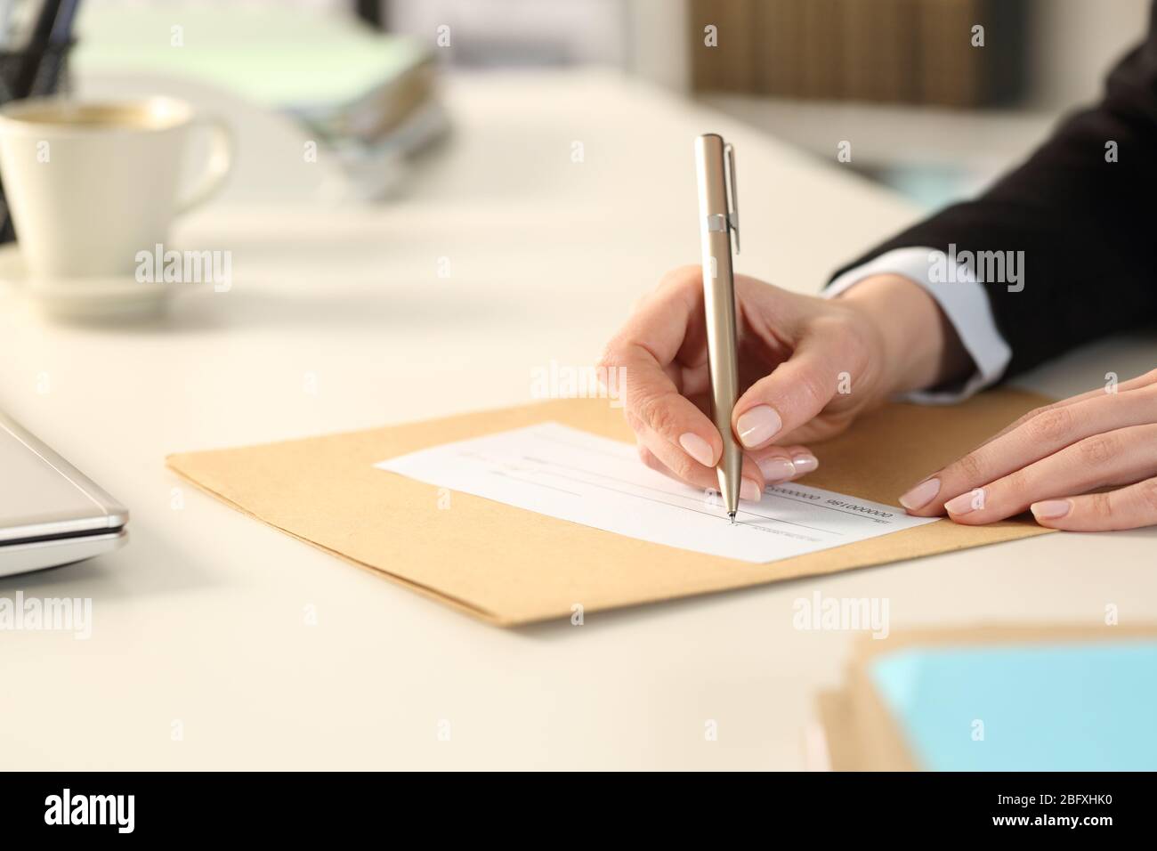 Female hand writing cheque hi-res stock photography and images - Alamy