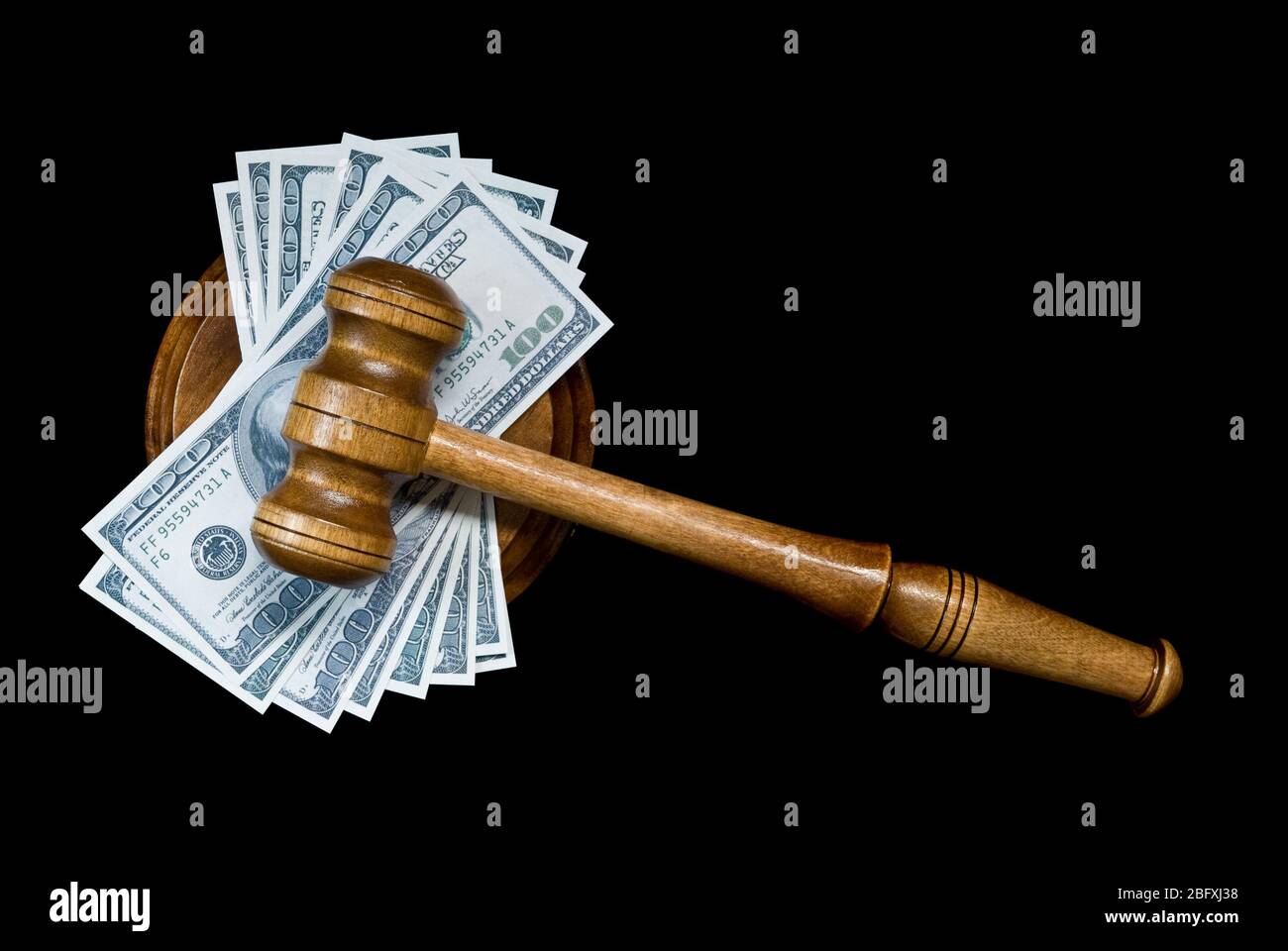 Wood gavel, soundblock and bank notes on a black background. Allegory ...