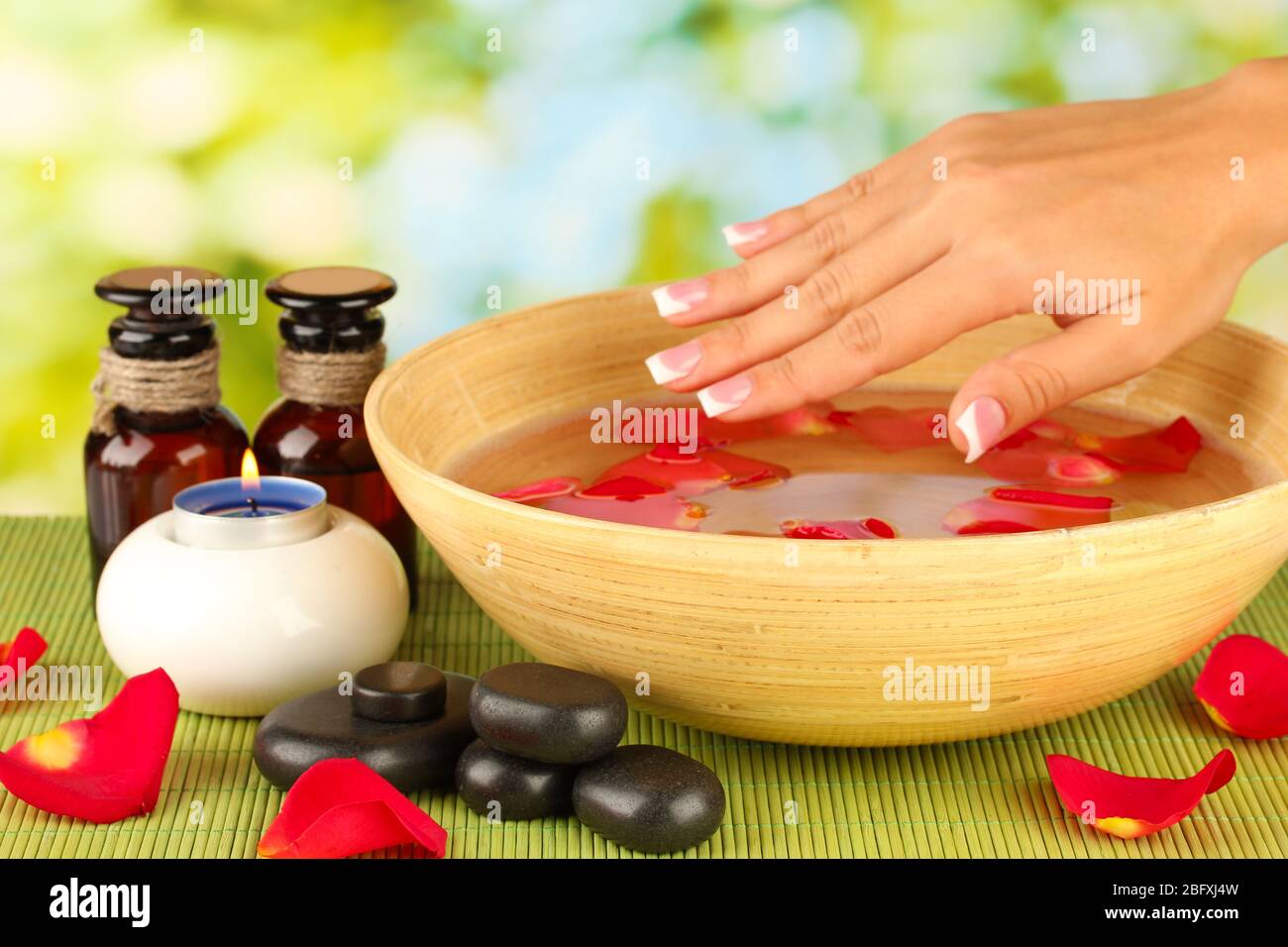 spa treatments for female hands, on green background Stock Photo - Alamy