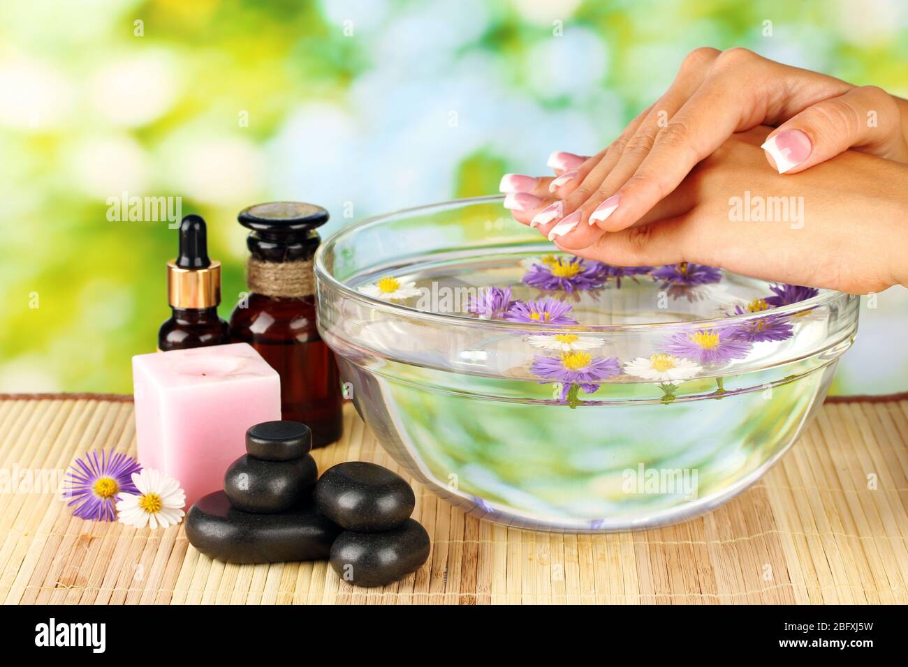 spa treatments for female hands, on bright green background Stock Photo ...