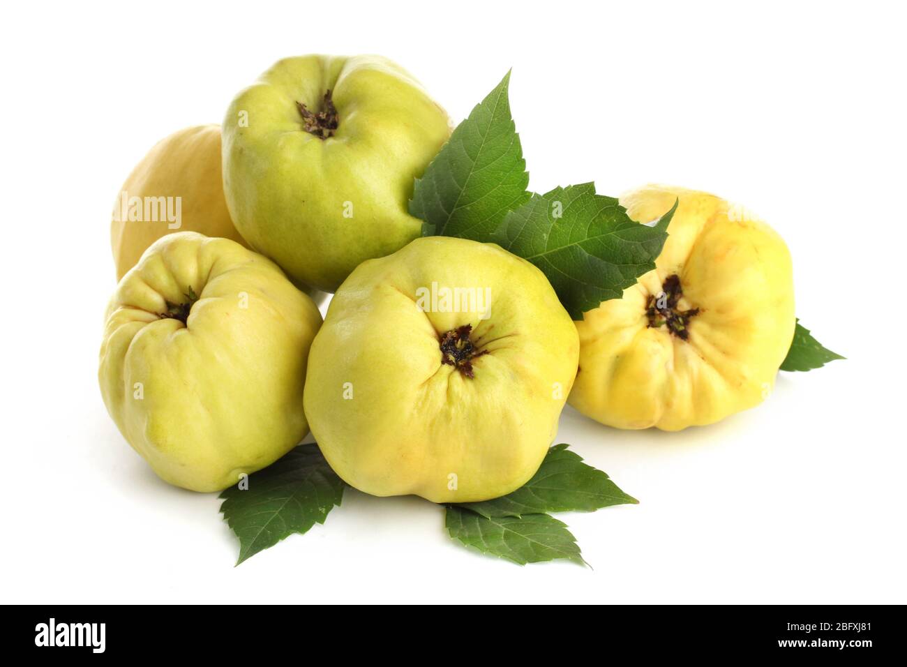sweet quinces with leaves, isolated on white Stock Photo - Alamy