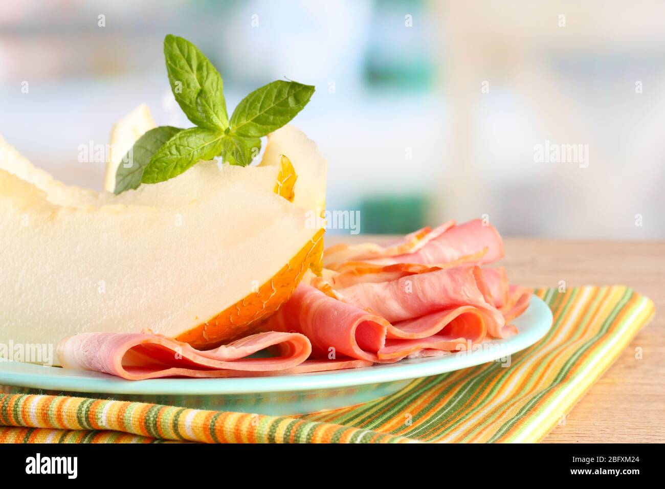 parma ham and melon, on wooden table Stock Photo - Alamy