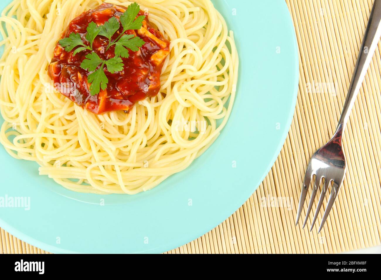 Italian spaghetti in plate on bamboo mat Stock Photo - Alamy