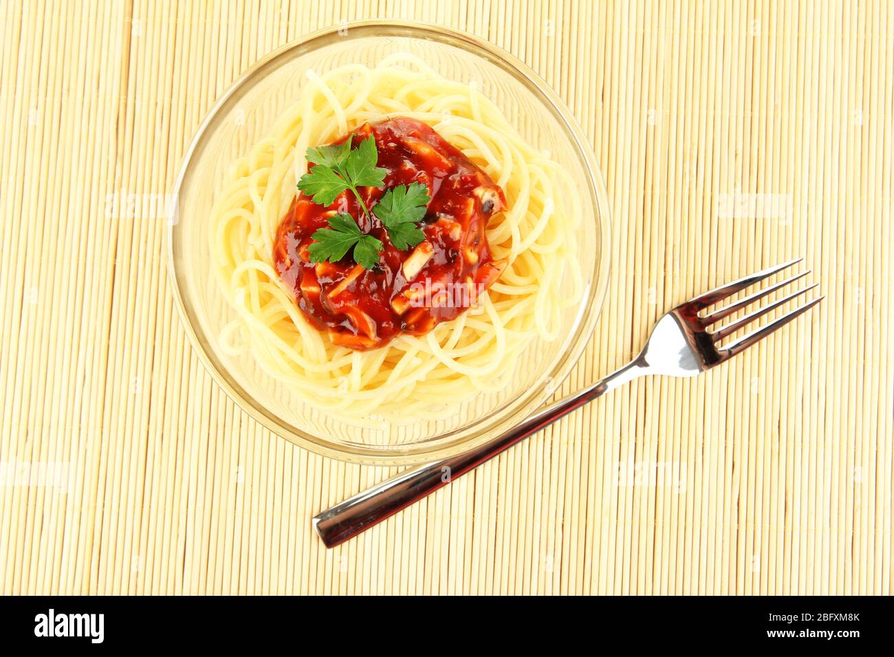 Italian spaghetti in plate on bamboo mat Stock Photo - Alamy