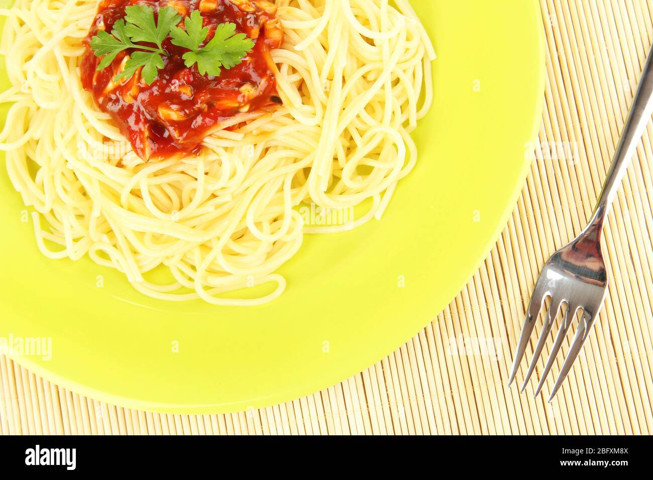 Italian spaghetti in plate on bamboo mat Stock Photo - Alamy