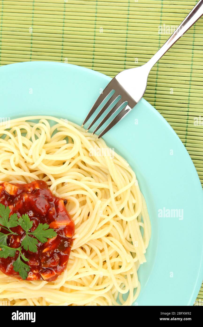Italian spaghetti in plate on bamboo mat Stock Photo - Alamy