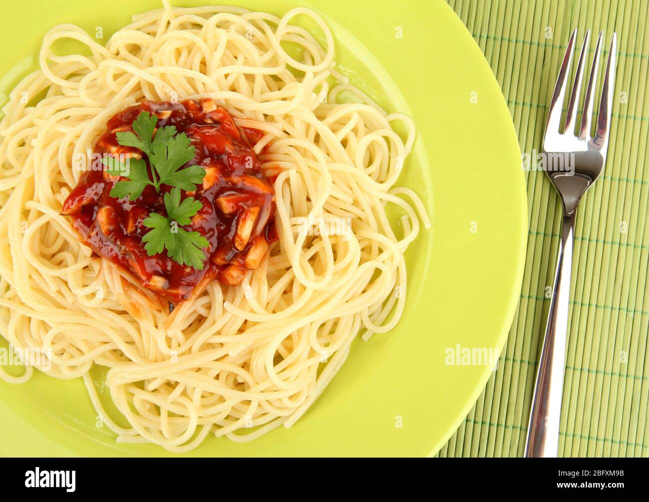 Italian spaghetti in plate on bamboo mat Stock Photo - Alamy