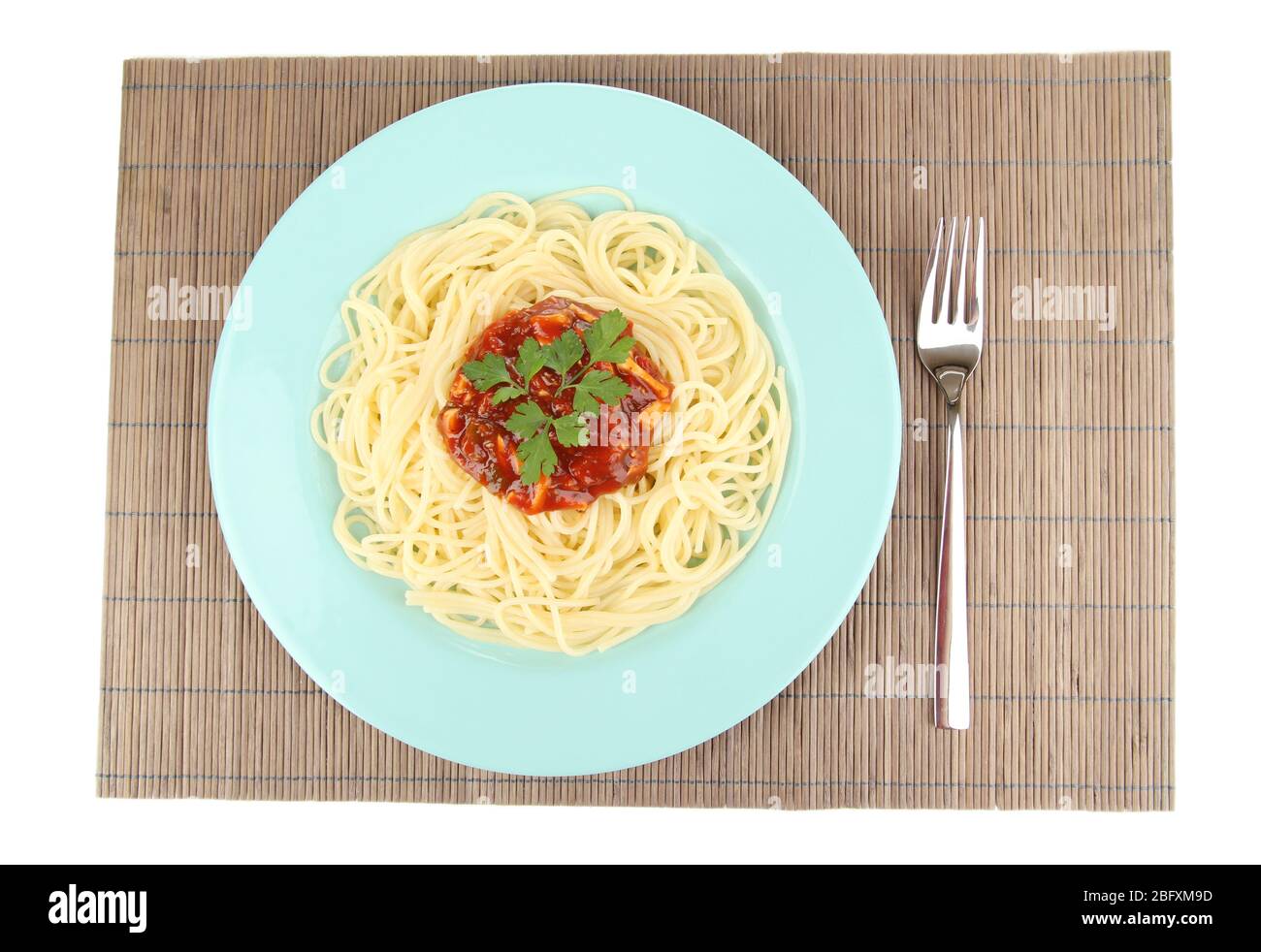 Italian spaghetti in plate on bamboo mat Stock Photo - Alamy