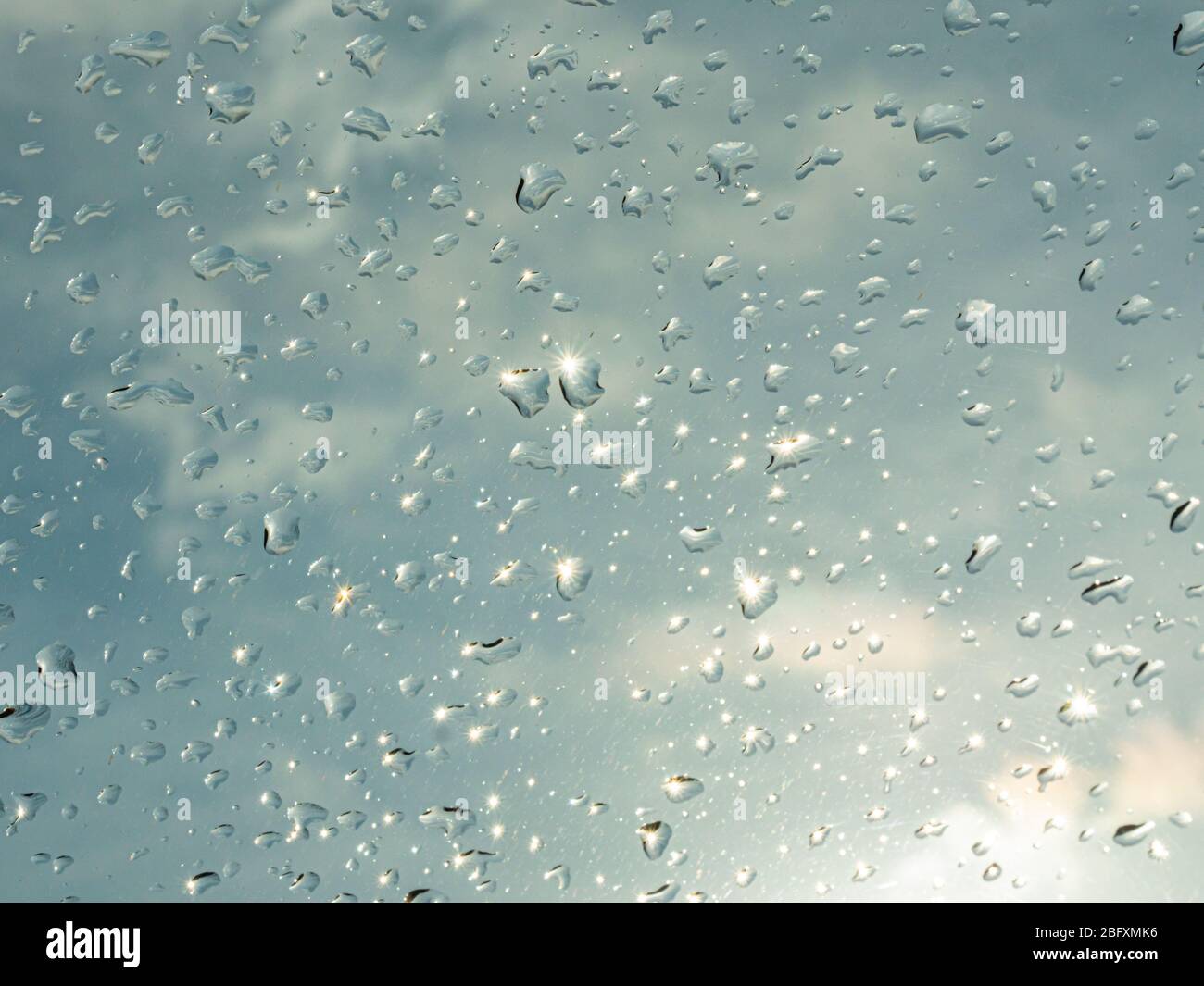 Wet window with rain drops and a cloudy sky outside background Stock ...
