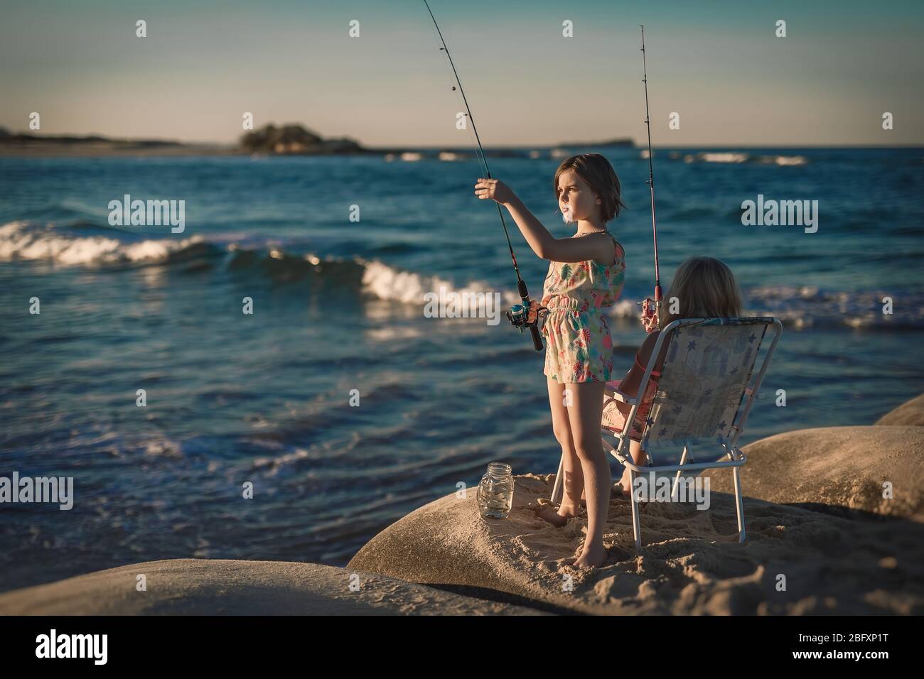 Two girls fishing hi-res stock photography and images - Alamy