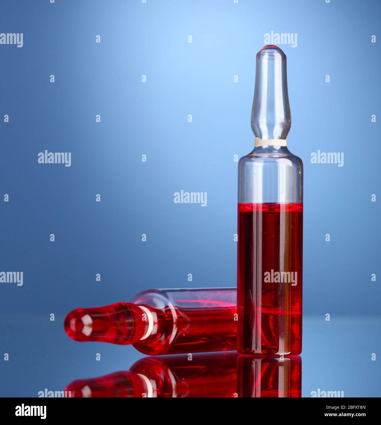 medical ampules on blue background Stock Photo - Alamy