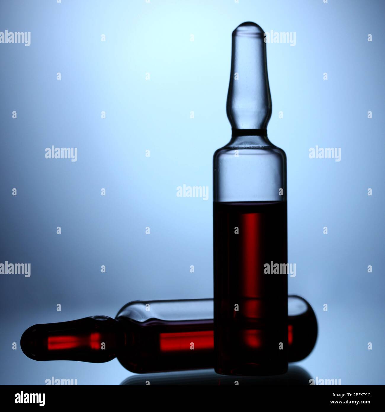 medical ampules on blue background Stock Photo - Alamy