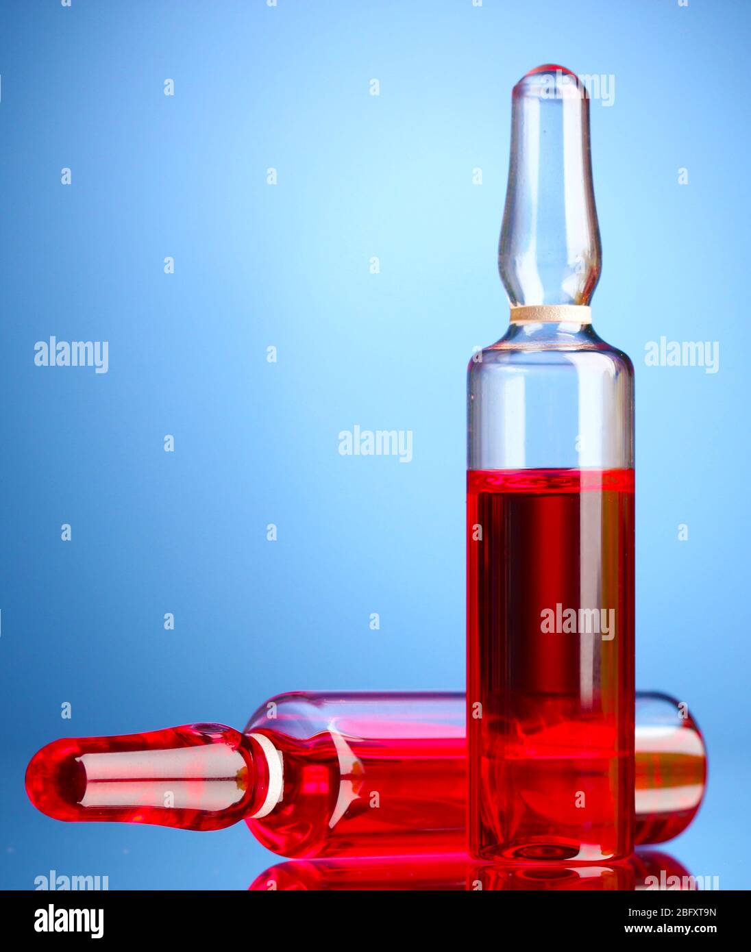 medical ampules on blue background Stock Photo - Alamy