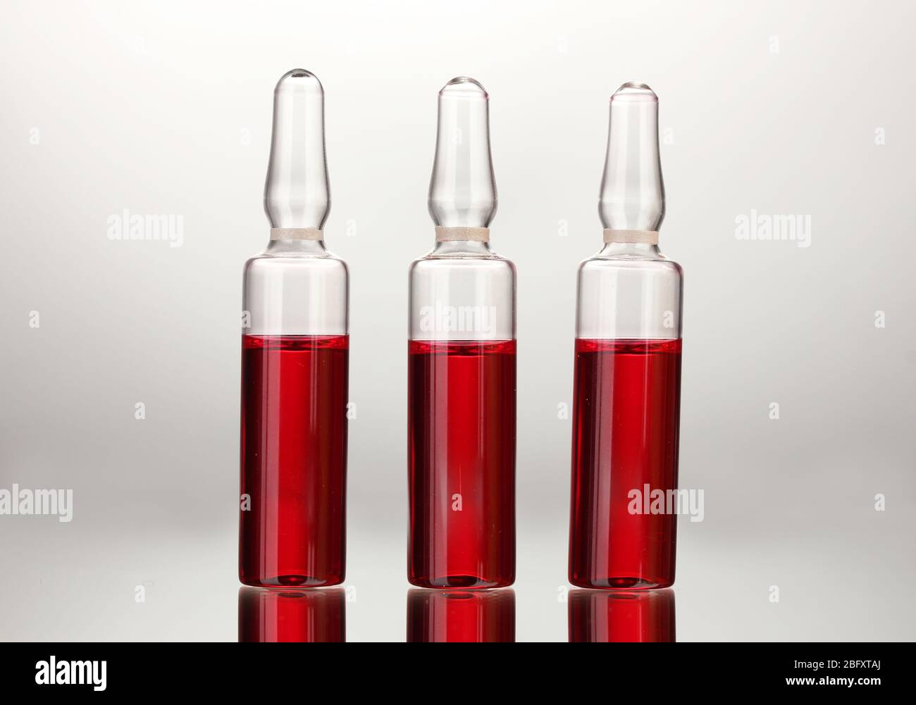 medical ampules on grey background Stock Photo - Alamy