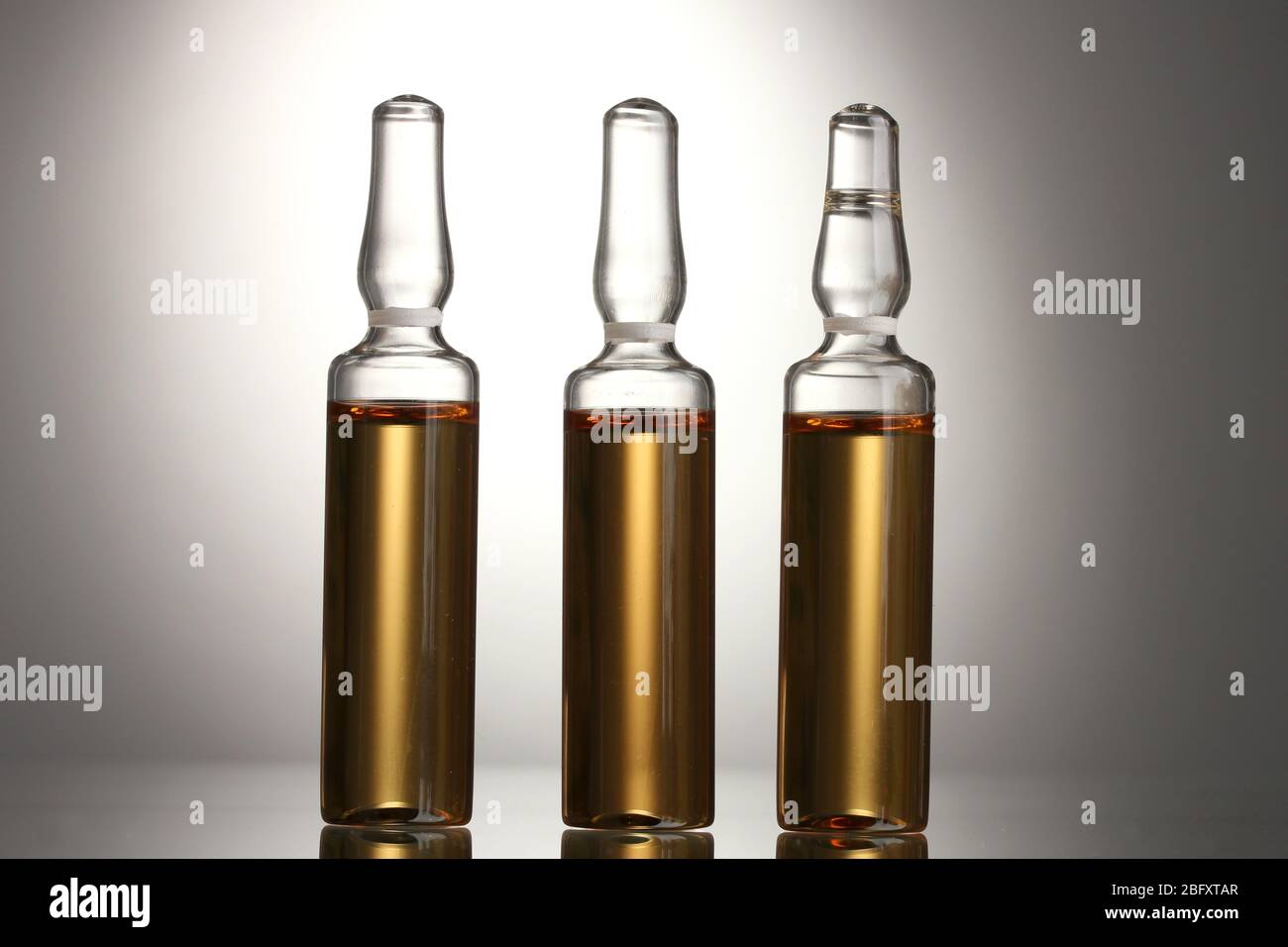 medical ampules on grey background Stock Photo - Alamy