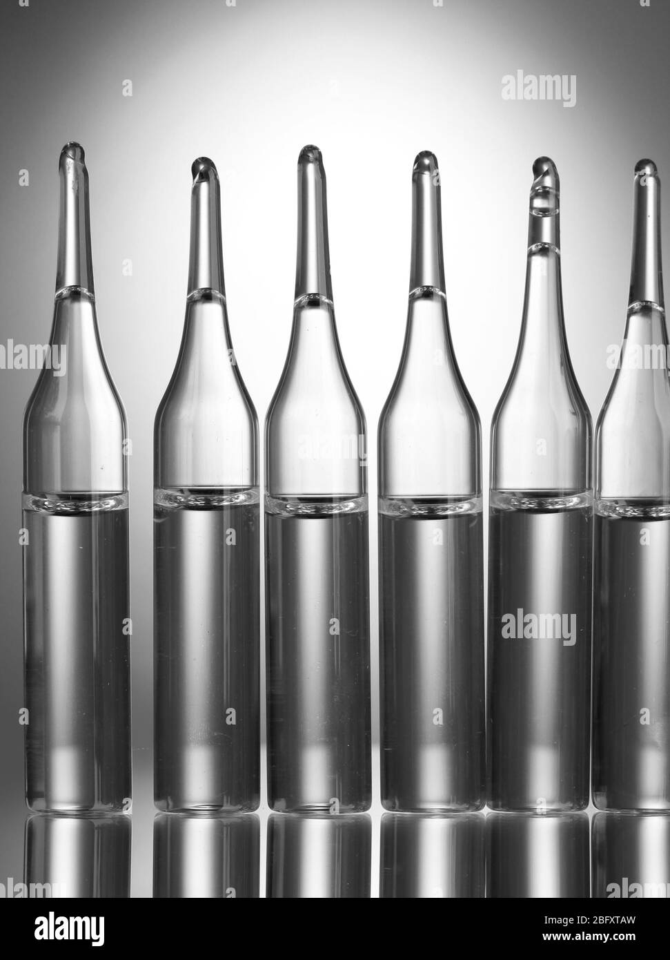 medical ampules on grey background Stock Photo - Alamy