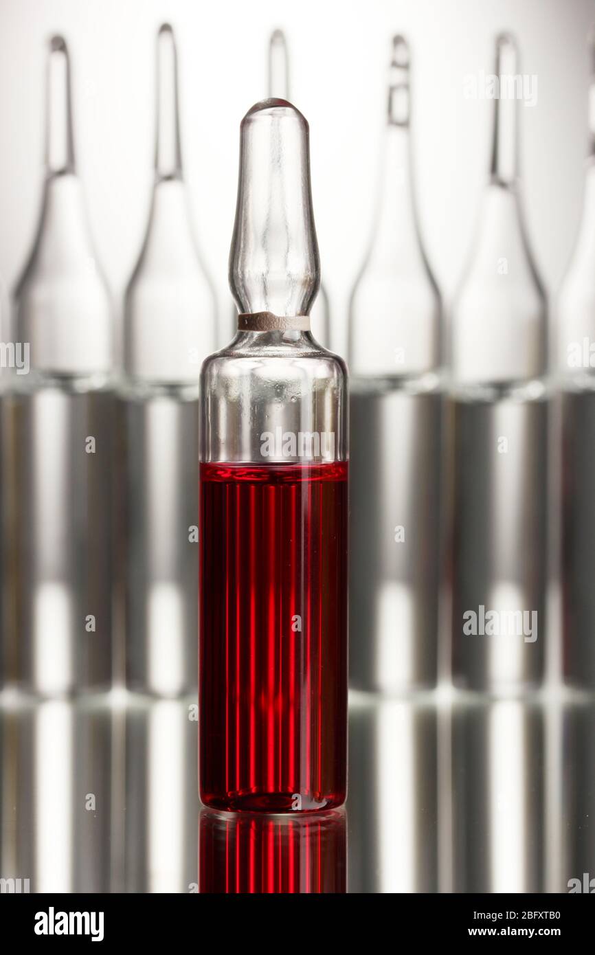 medical ampules on grey background Stock Photo - Alamy