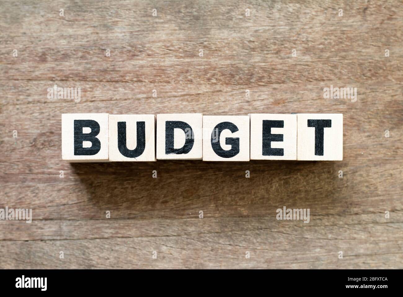 Letter block in word budget on wood background Stock Photo - Alamy