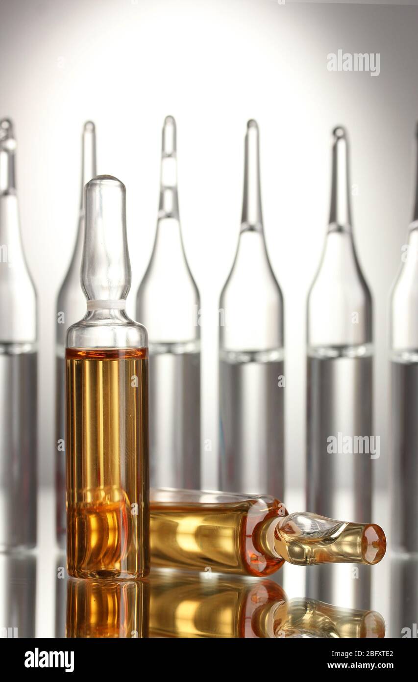 medical ampules on grey background Stock Photo - Alamy