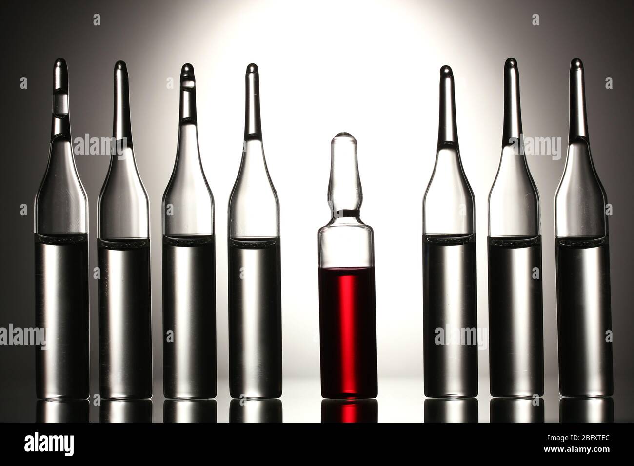 medical ampules on grey background Stock Photo - Alamy